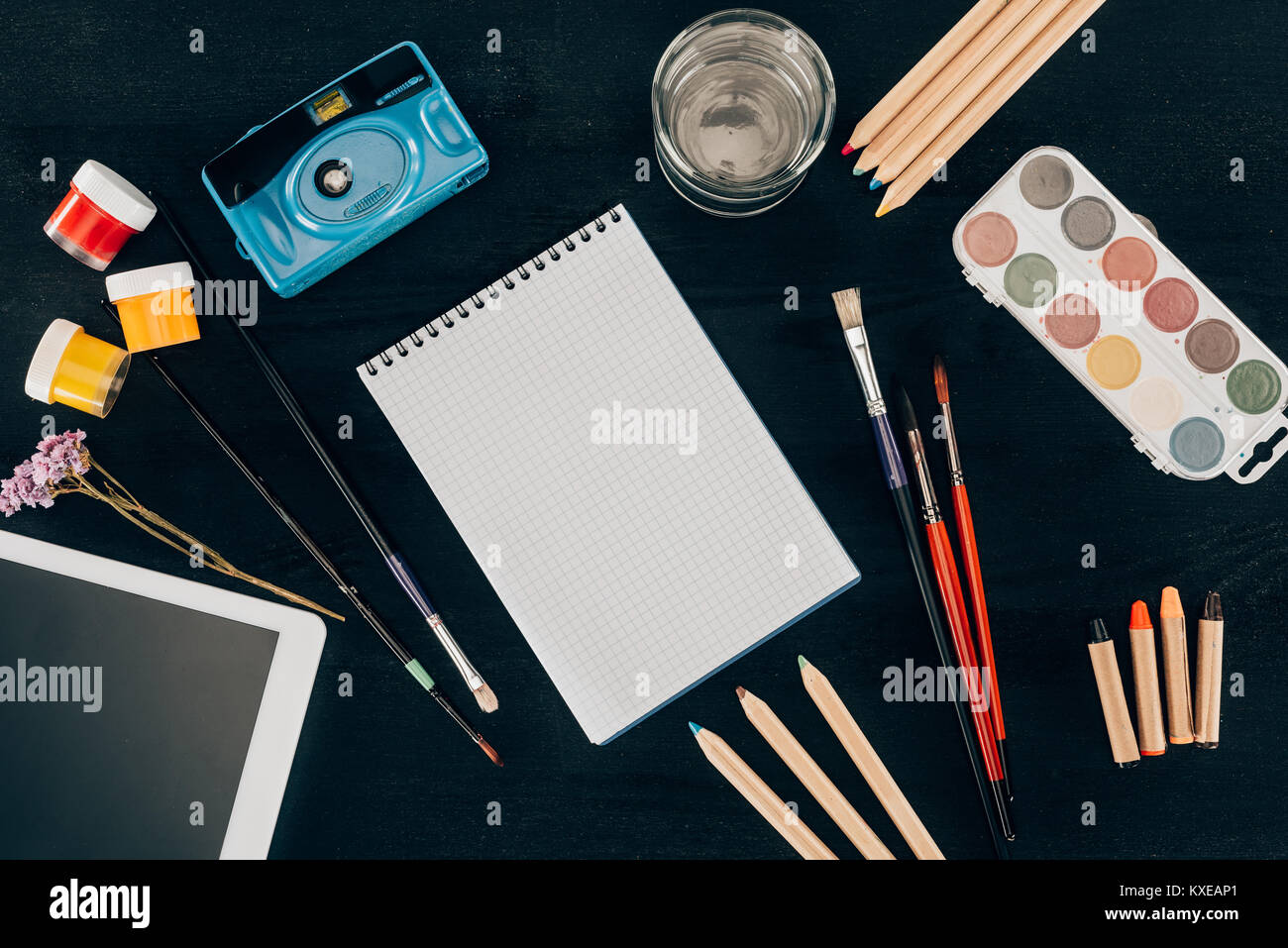 Top view of composition of colorful school supplies with blank notebook ...