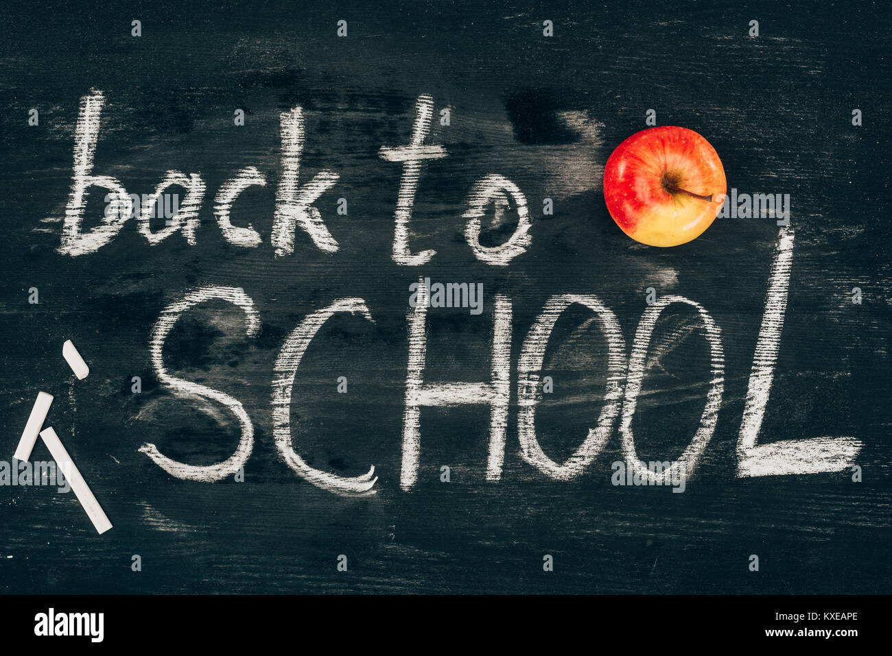 Back to school inscription on chalk board with apple Stock Photo - Alamy