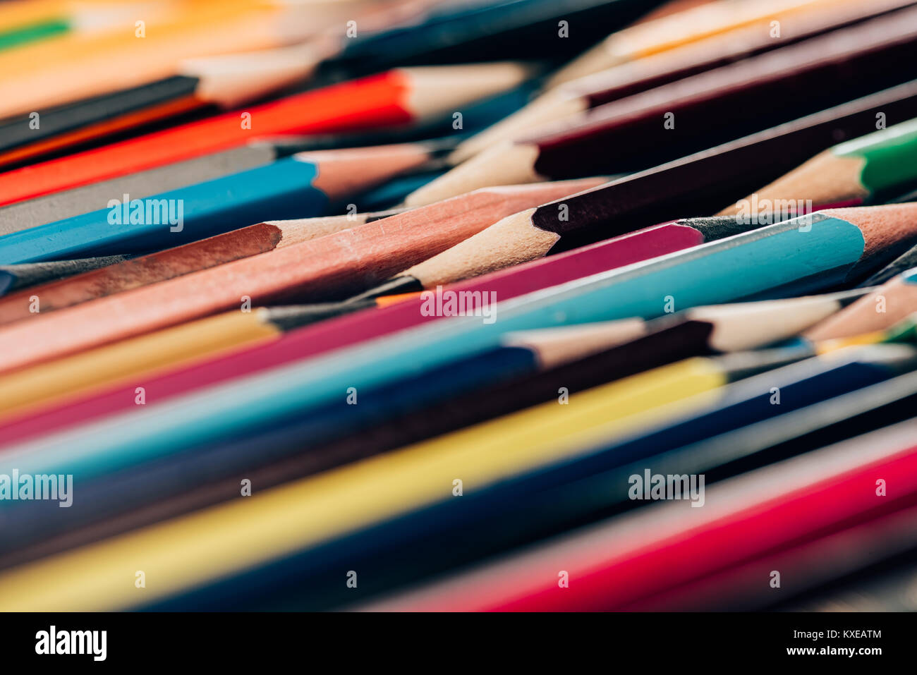 Close-up view of colorful pencils in mess as educational background ...