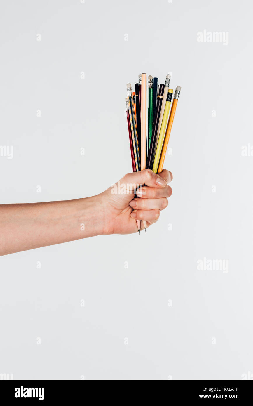 Close-up view of female hand with colorful pencils isolated on white ...
