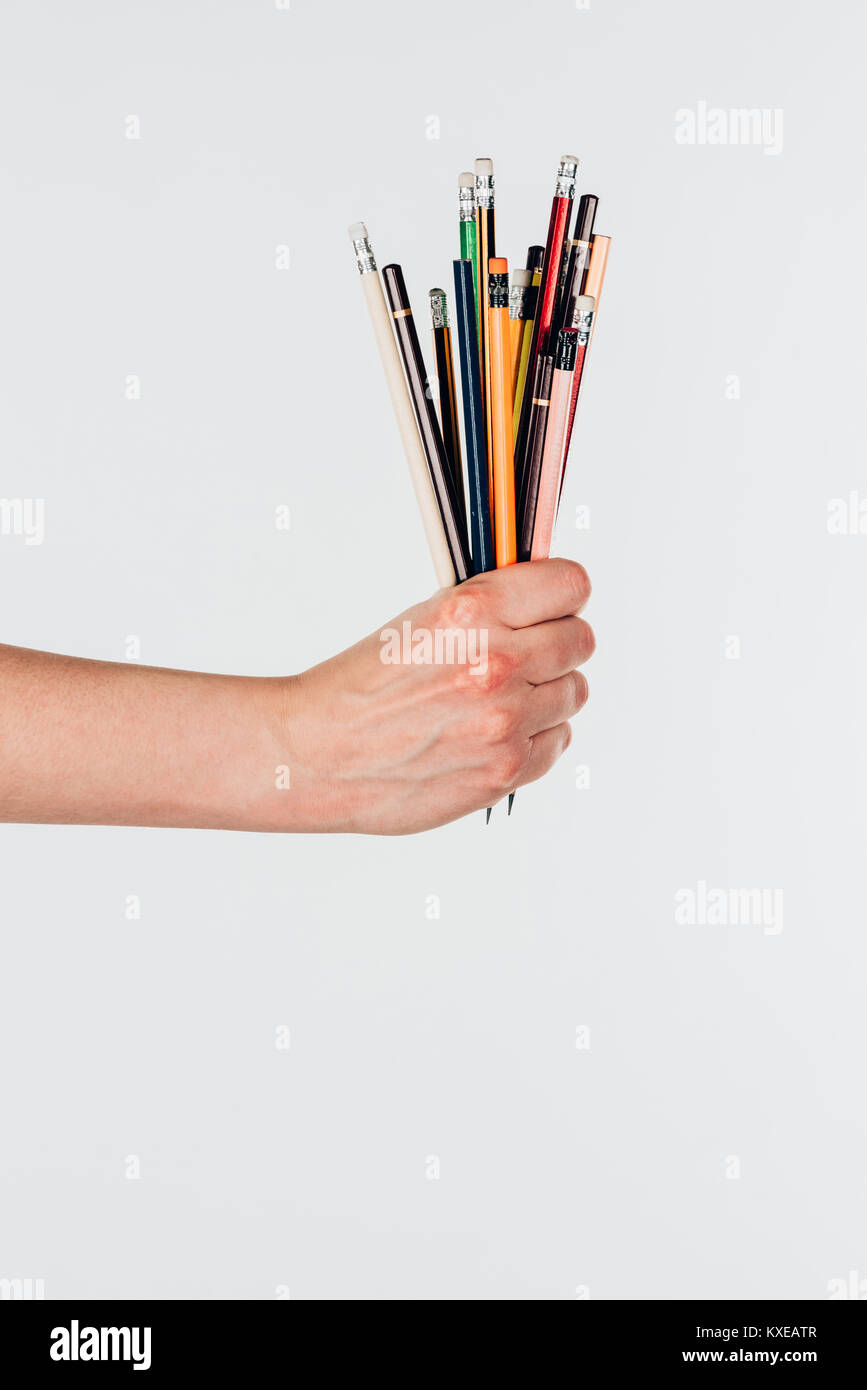 Close-up view of female hand with colorful pencils isolated on white ...