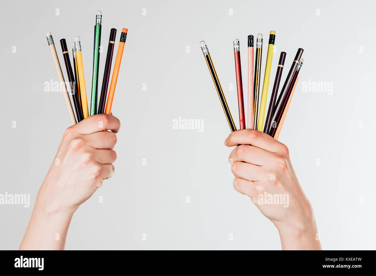 Close-up view of female hands with colorful pencils isolated on white ...