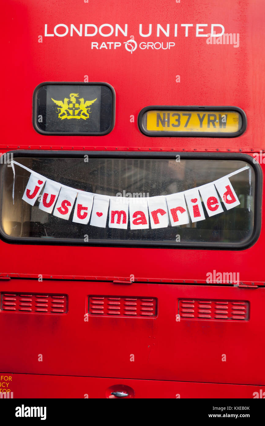 A Just Married sign hangs in the back of a red London bus Stock Photo ...