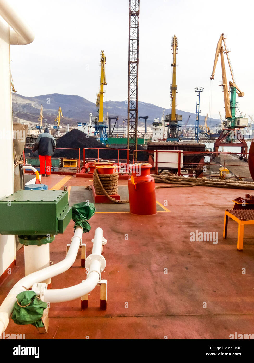 View of the sea and city beach from the port quay. Industrial port with ...
