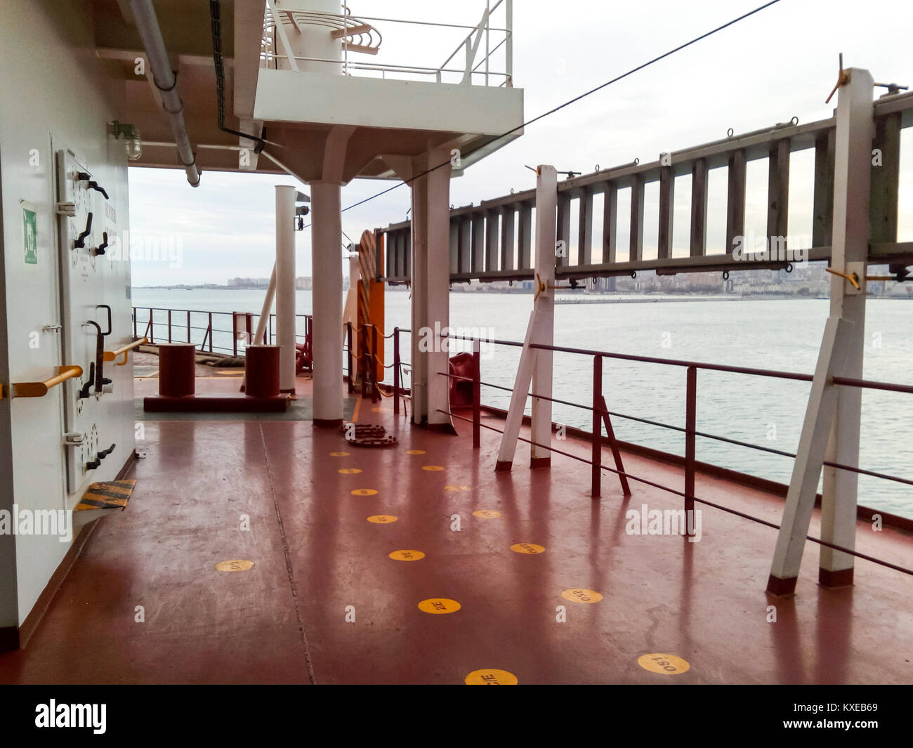 The deck of a cargo ship. Red floor and white walls Stock Photo - Alamy