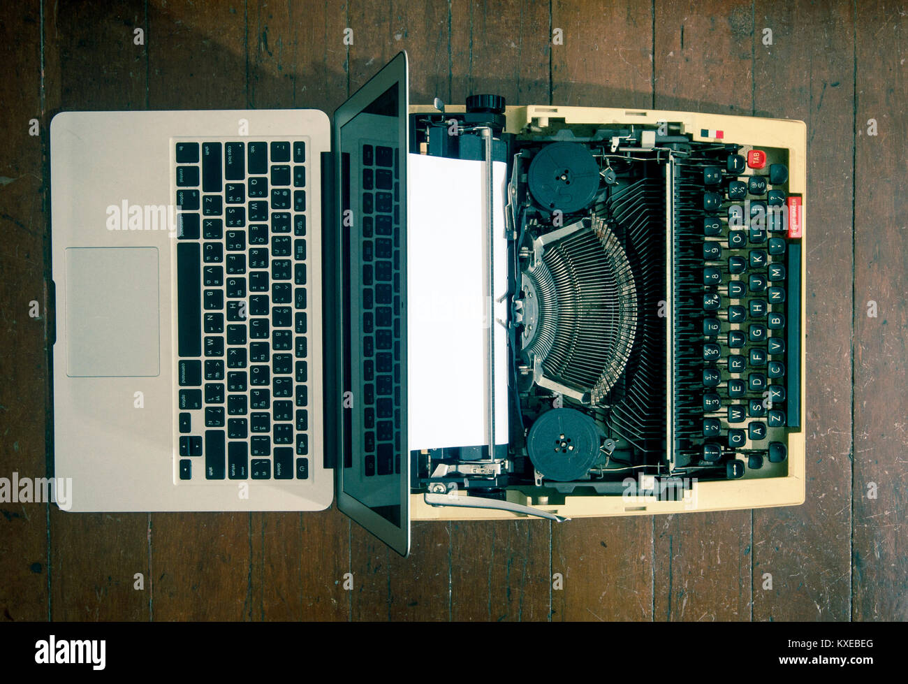 concept old and new a new note book next to an old typewriter from ...