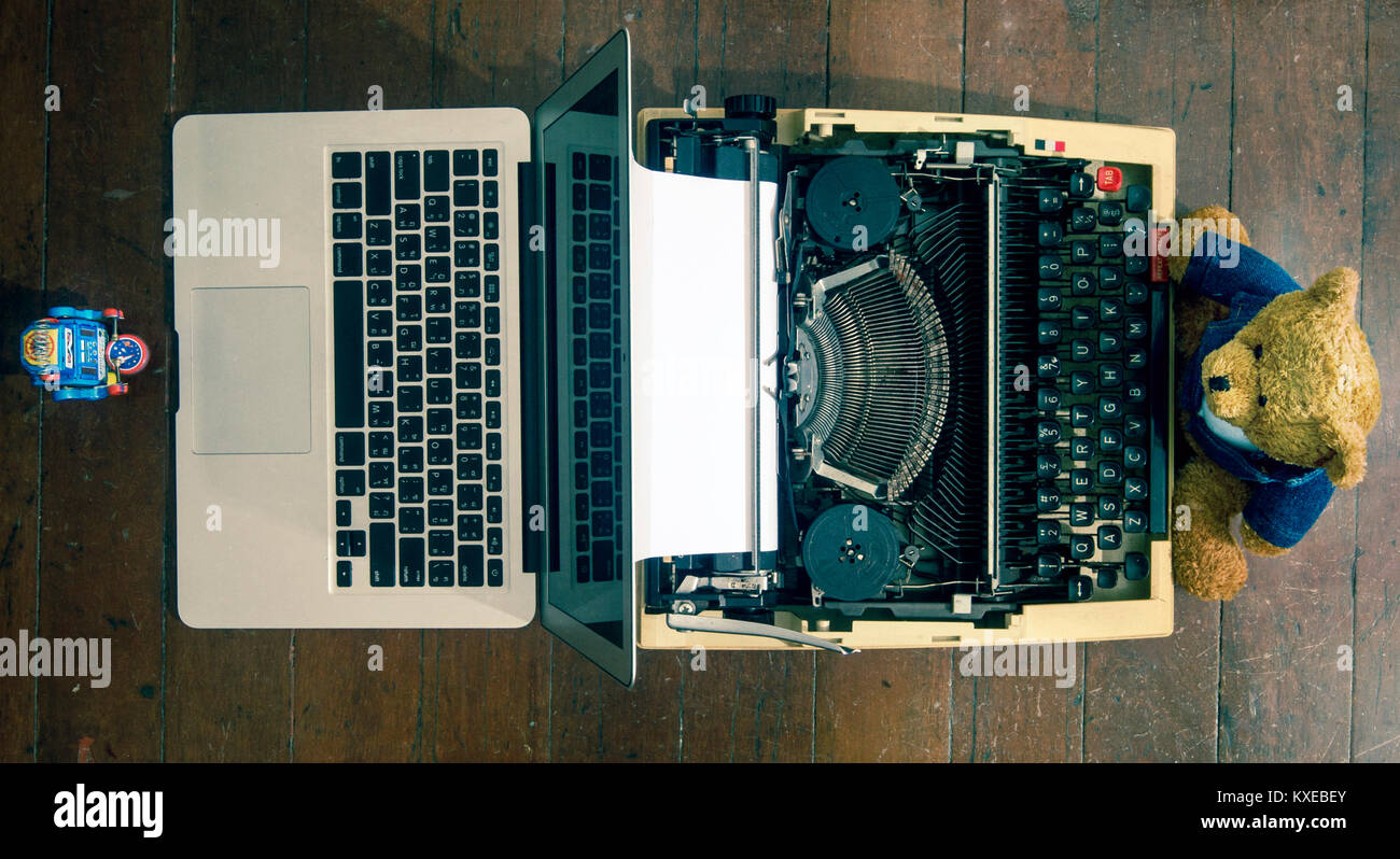 concept old and new a new note book next to an old typewriter from ...