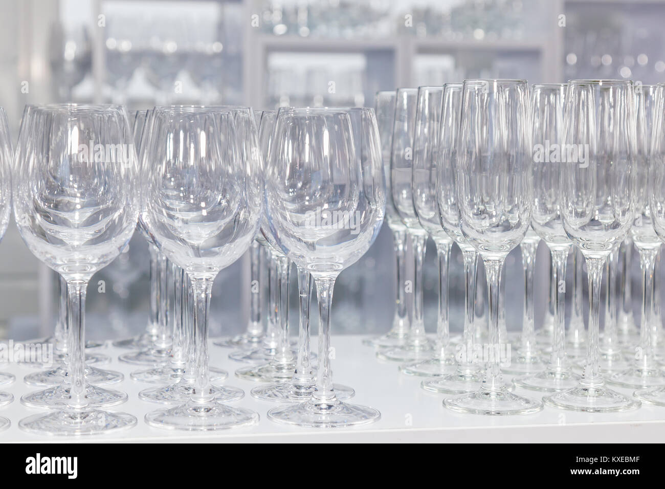 Empty glasses stand on a white table.Empty glasses Stock Photo - Alamy