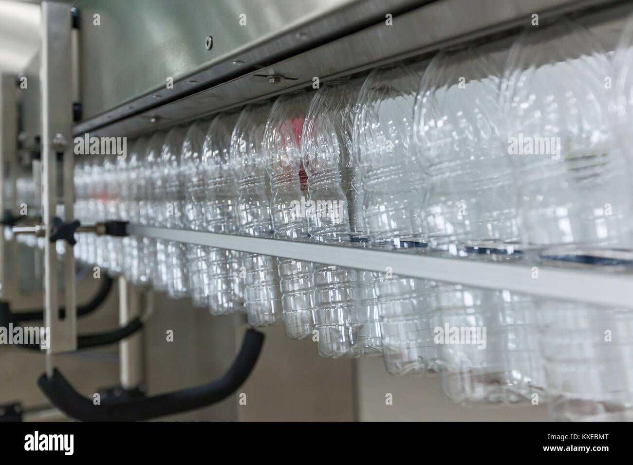 Plastic transparent bottles move on the conveyor.Plastic bottles on the ...