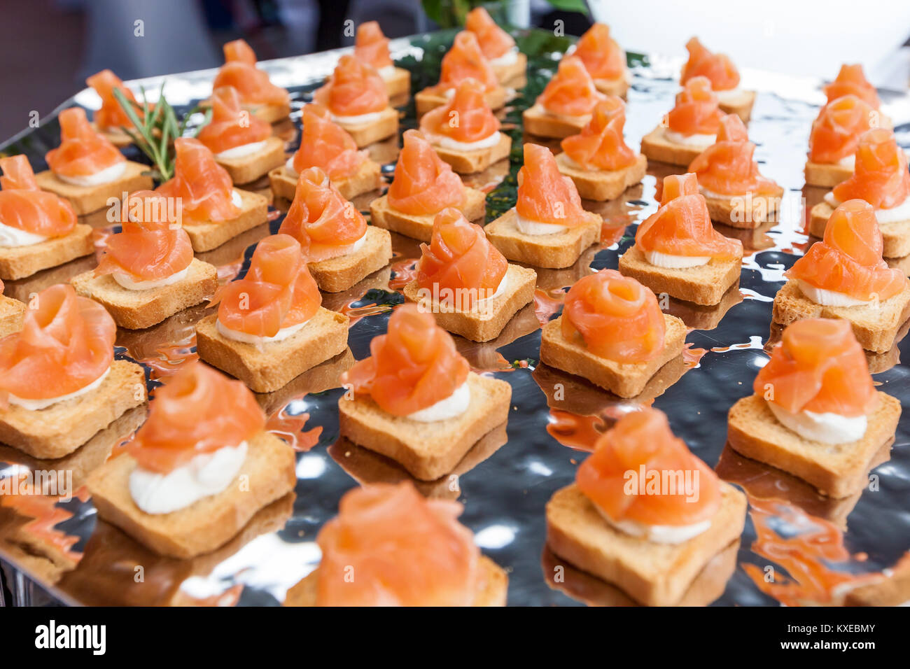 mini canapes with smoked salmon on a silver platter for a party. mini ...