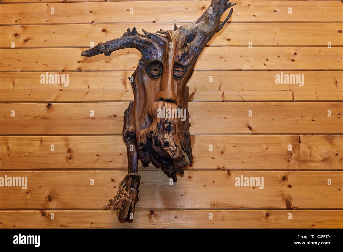 Wooden face with roots on a wooden background Stock Photo - Alamy