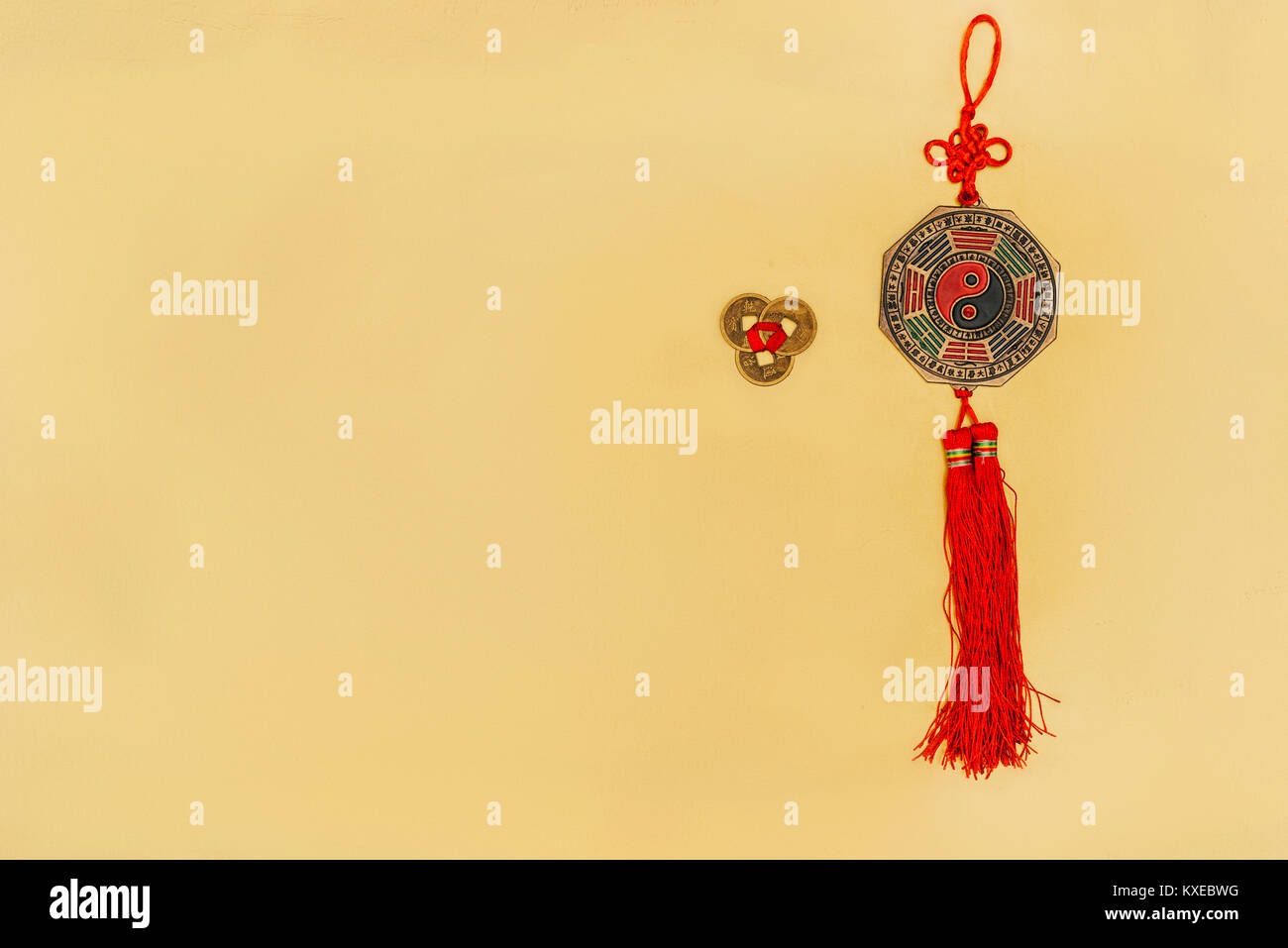 top view of chinese yin and yang talisman with coins on yellow Stock ...