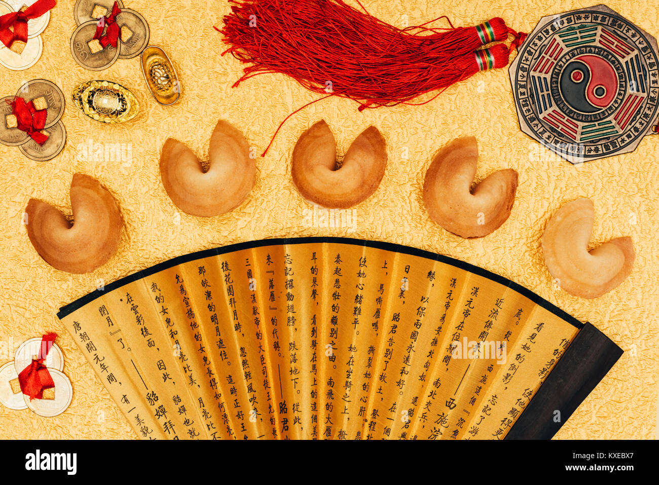 top view of chinese talismans and fortune cookies on golden surface ...
