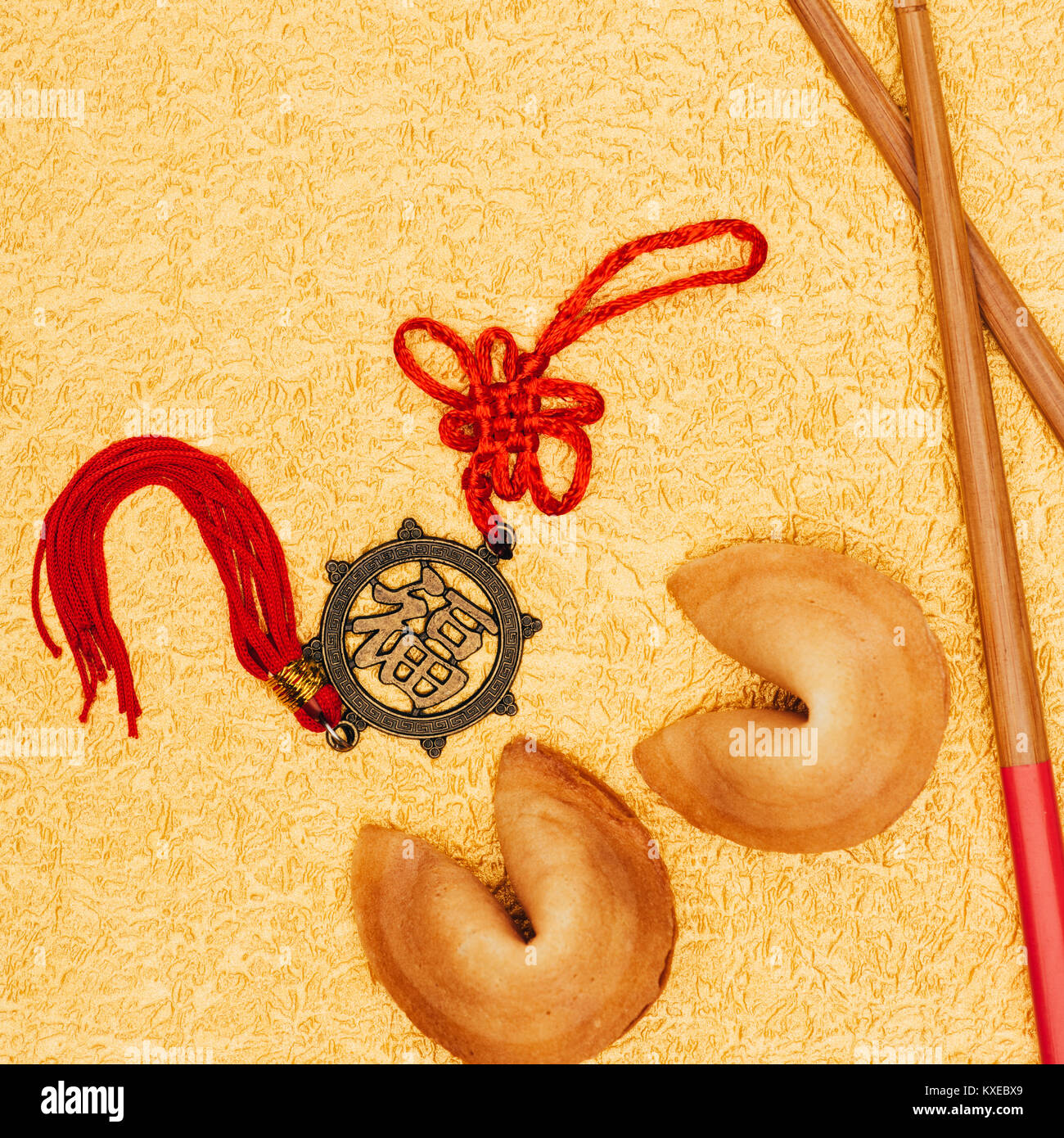 top view of chinese talisman and fortune cookies on golden surface ...