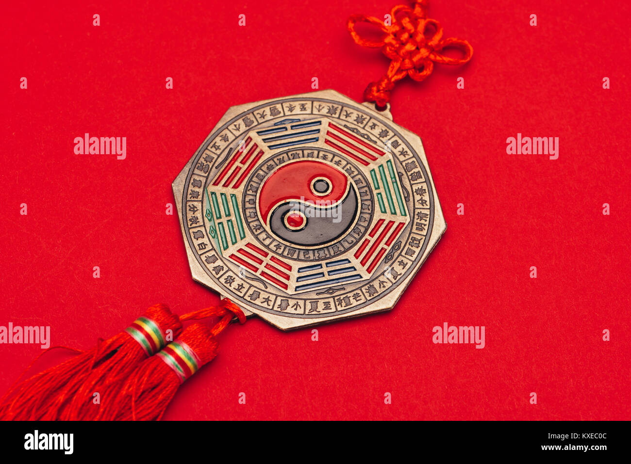 close-up shot of chinese yin and yang talisman on red surface Stock ...