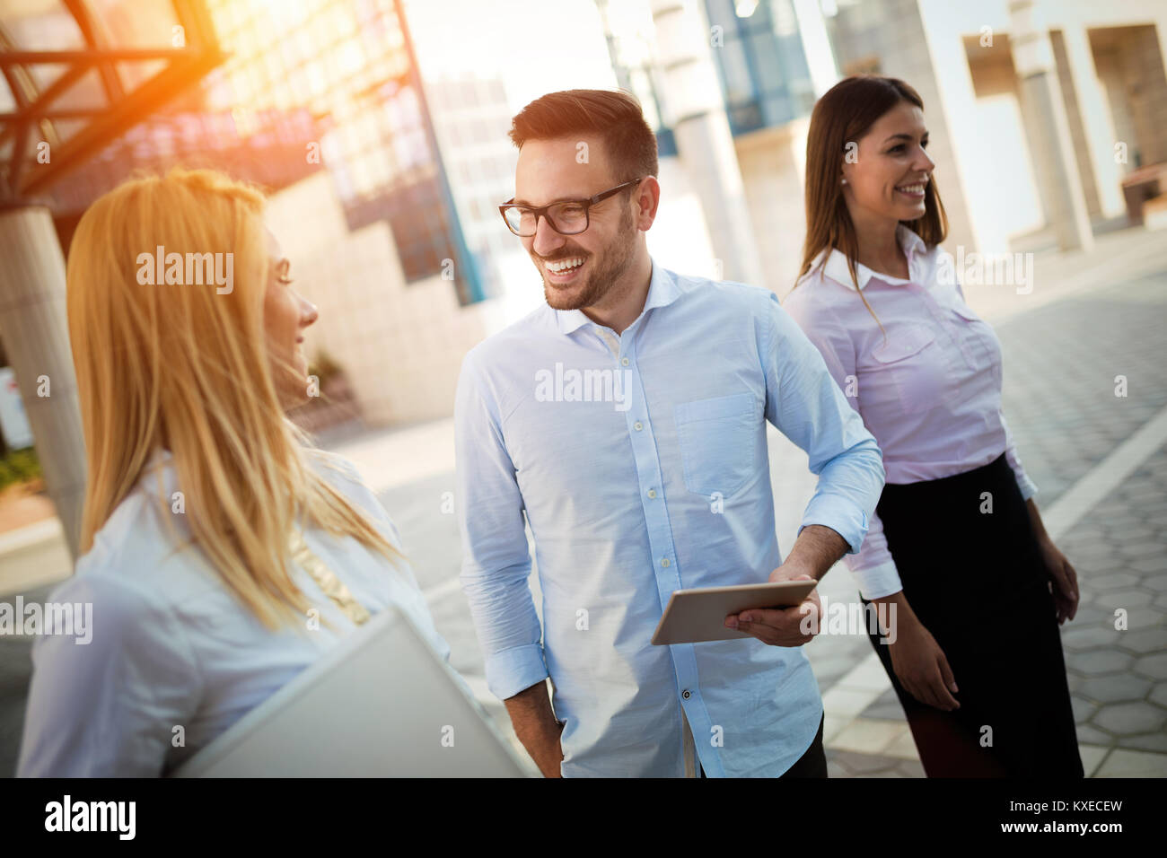 Picture of young attractive business partners standing Stock Photo - Alamy