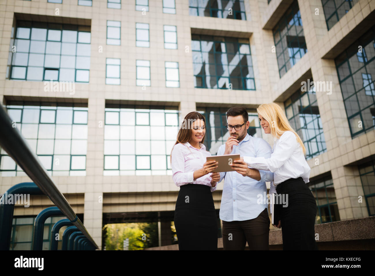 Picture of young attractive business partners standing Stock Photo - Alamy