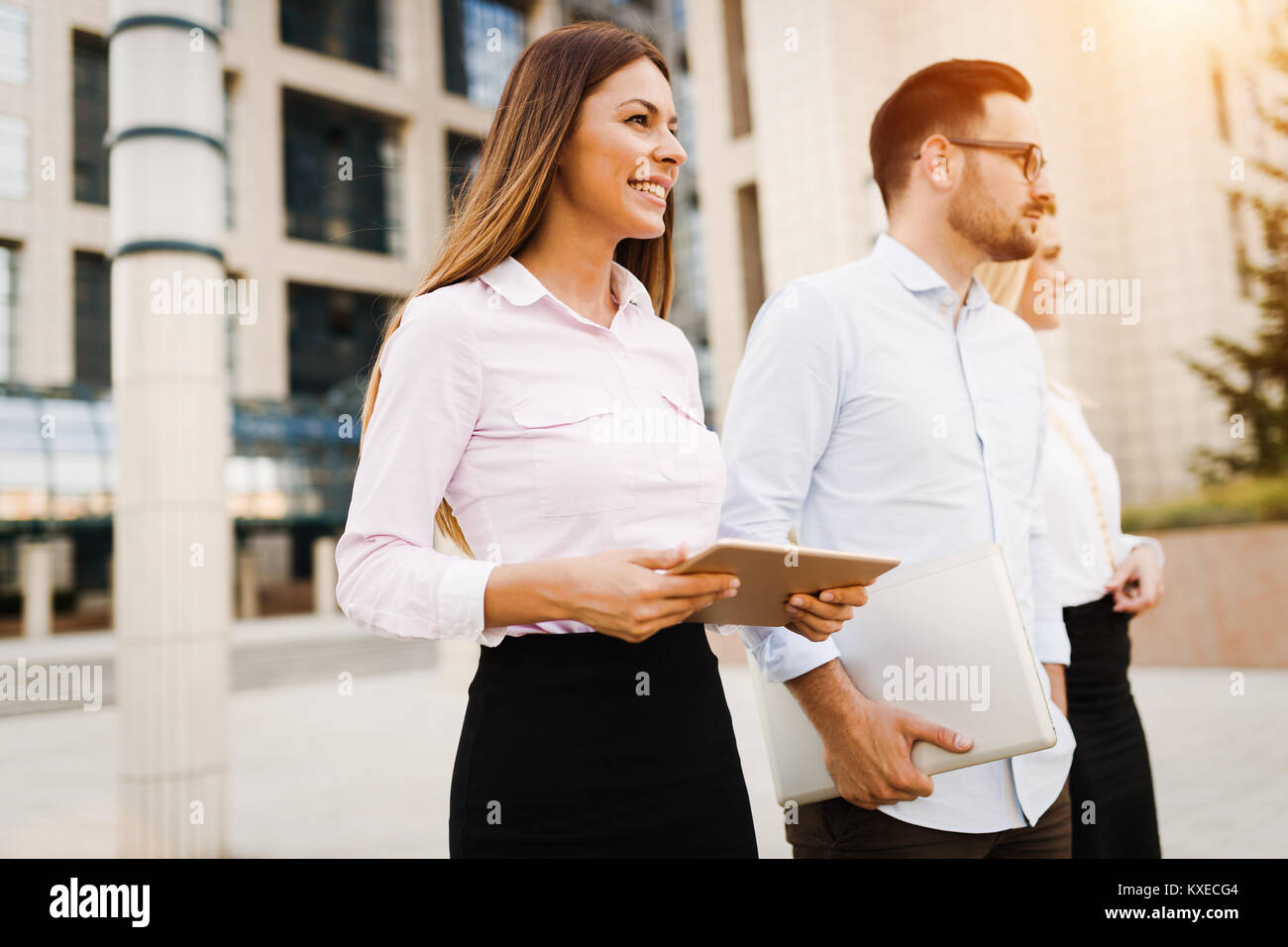 Picture of young attractive business partners standing Stock Photo - Alamy