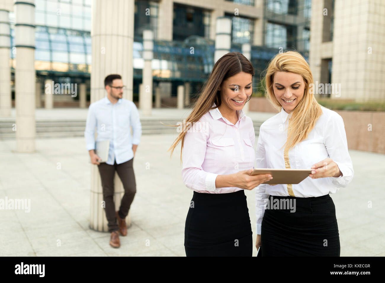 Picture of young attractive business partners standing Stock Photo - Alamy