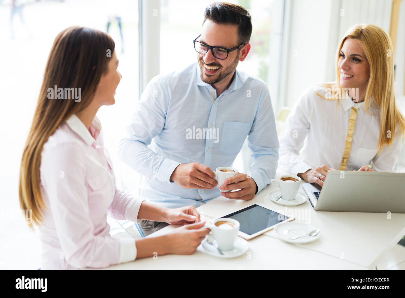 Happy colleagues casual chat at the office Stock Photo - Alamy