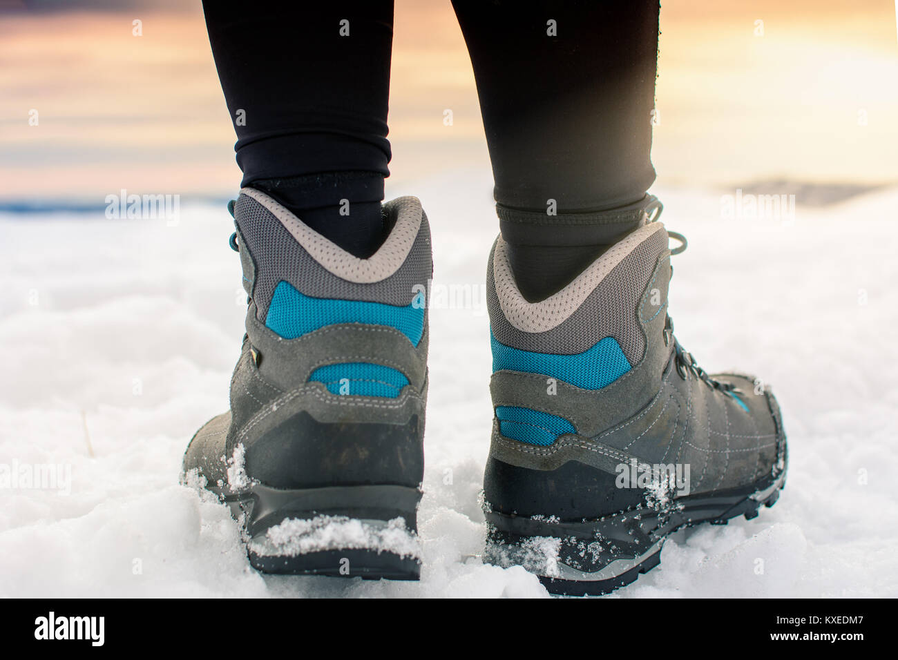 Person hiking on the mountaintop covered with snow low angle view Stock ...