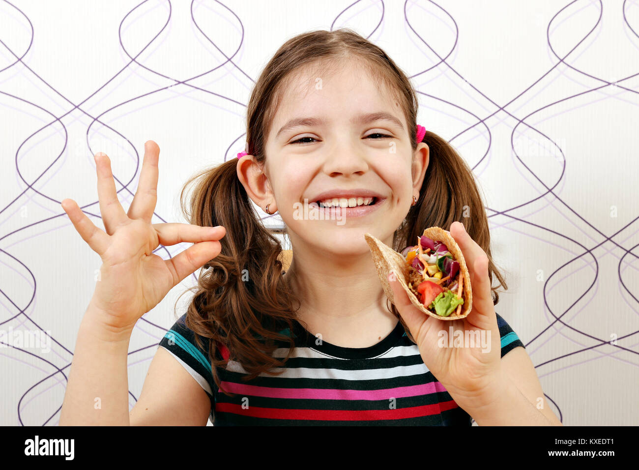 happy little girl with tacos and ok hand sign Stock Photo - Alamy