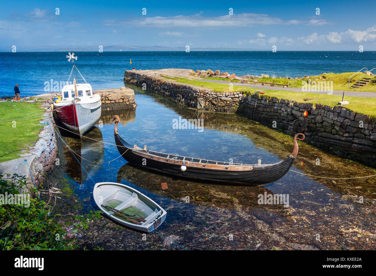 Viking style boat moored at Corrie harbour and village, Isle of Arran ...