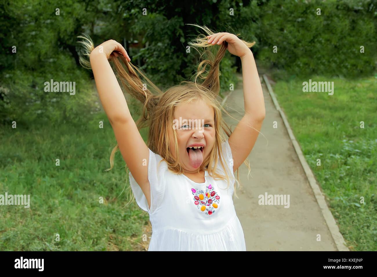 Portrait of girl with smile and makes faces Stock Photo - Alamy