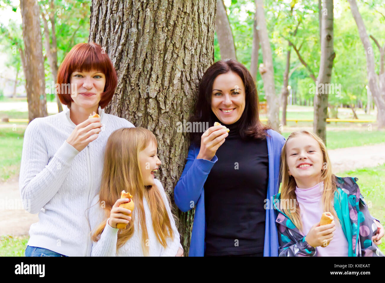 Photo of group laugh people are eating in summer Stock Photo - Alamy