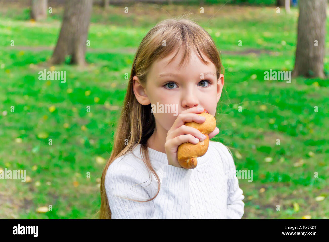 Photo of eating cute girl with long hair Stock Photo - Alamy
