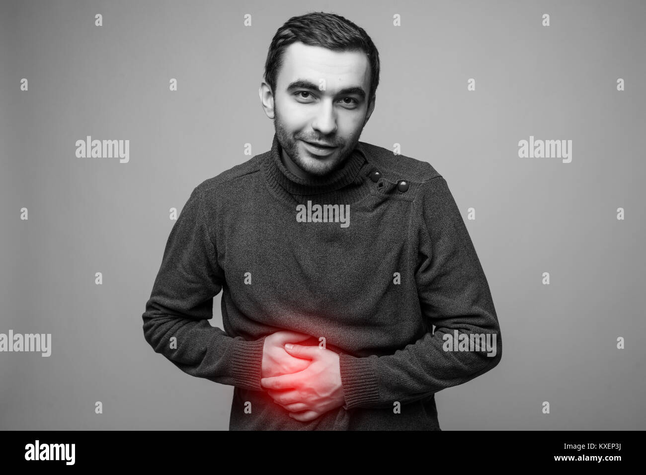 young man holding his sick stomach in pain, isolated on white ...