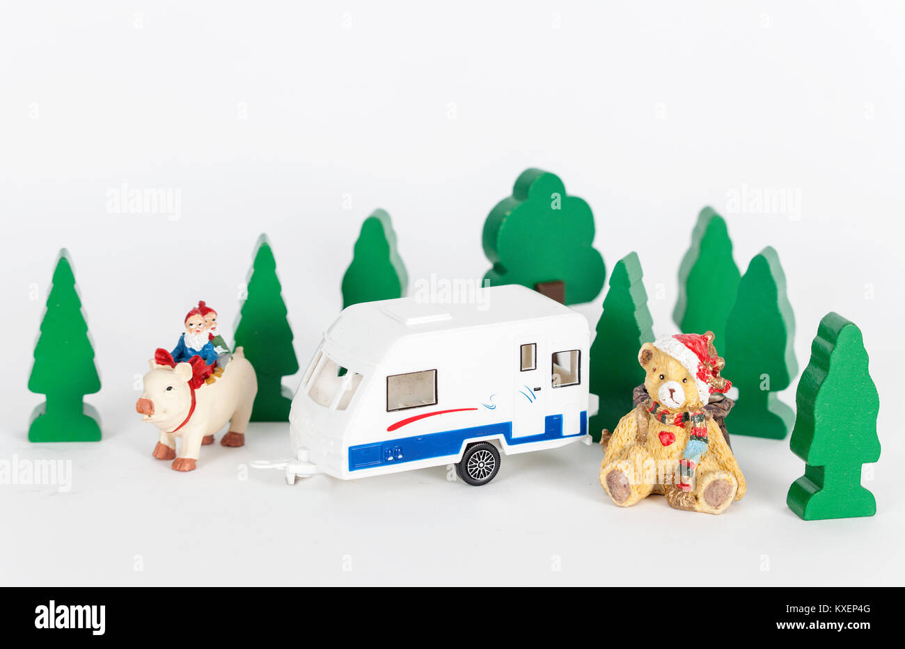 Mini figures, trees and a toy caravan on white. Christmas decoration ...