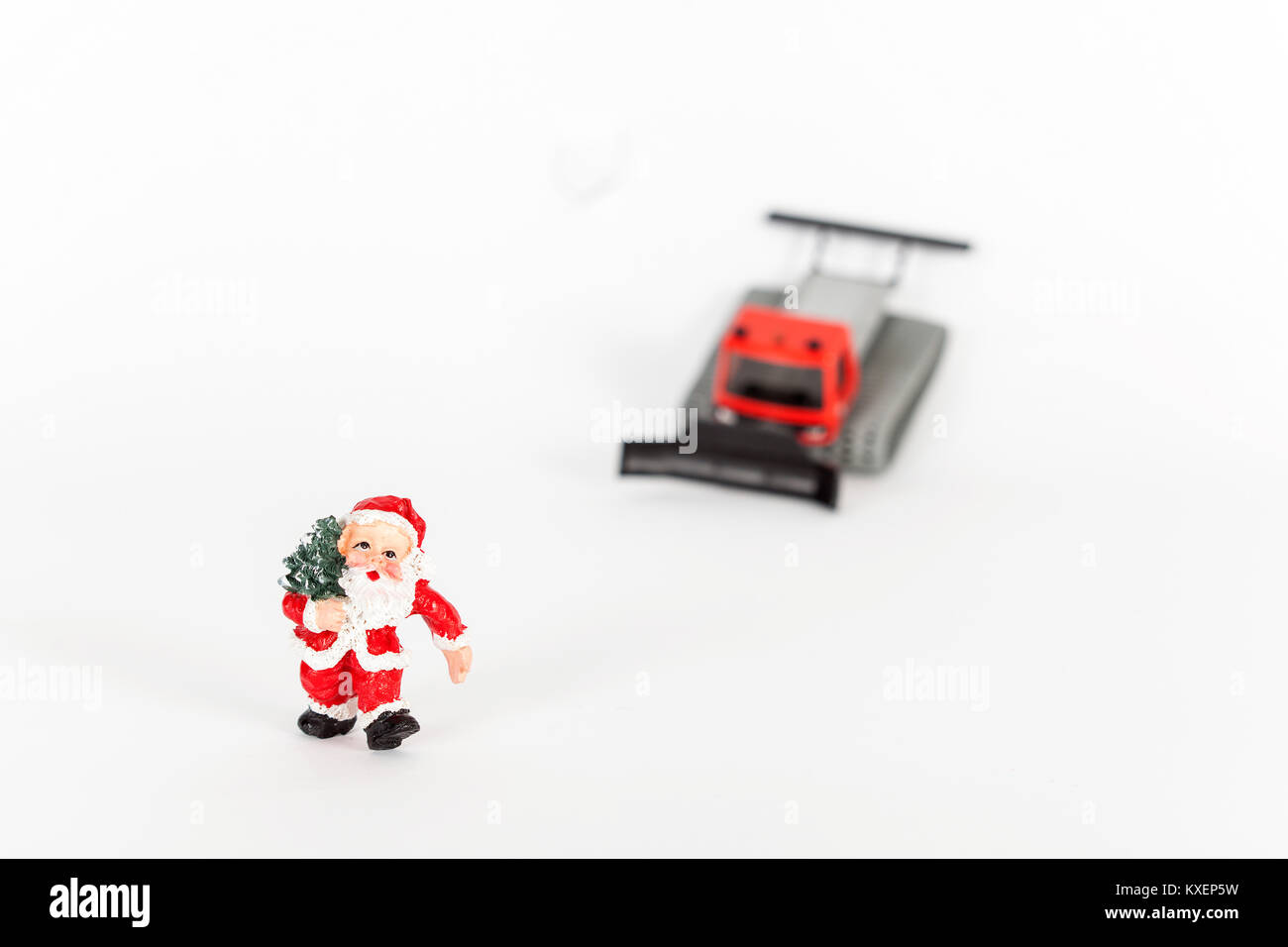 Red and white mini figure riding in white snow. Christmas decoration ...