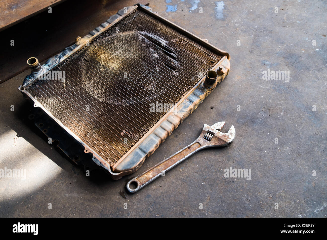 Old radiator with wrench, repair Stock Photo - Alamy