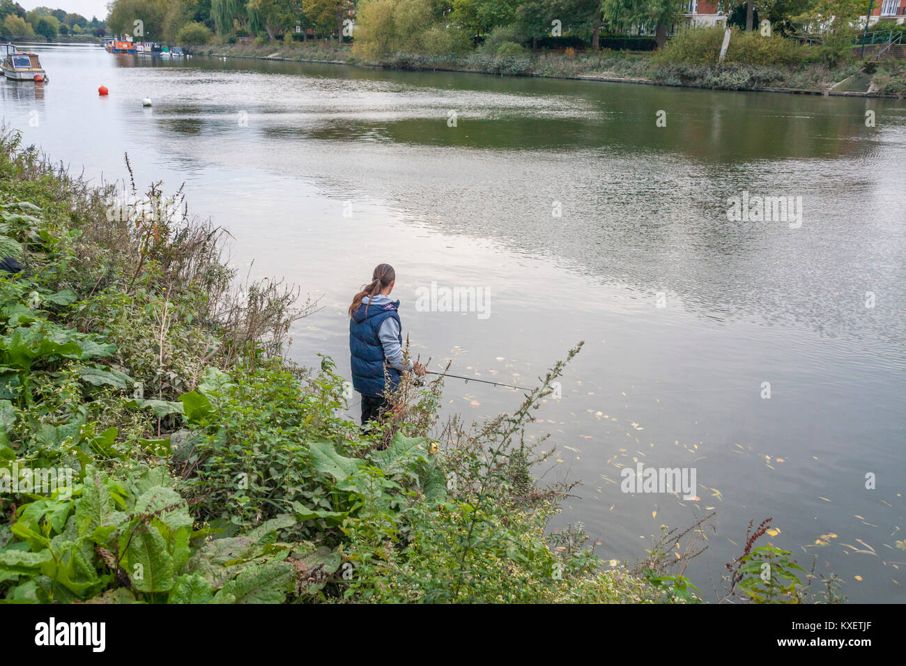 A man fishing at the riverside at Richmond upon Thames,London,England ...