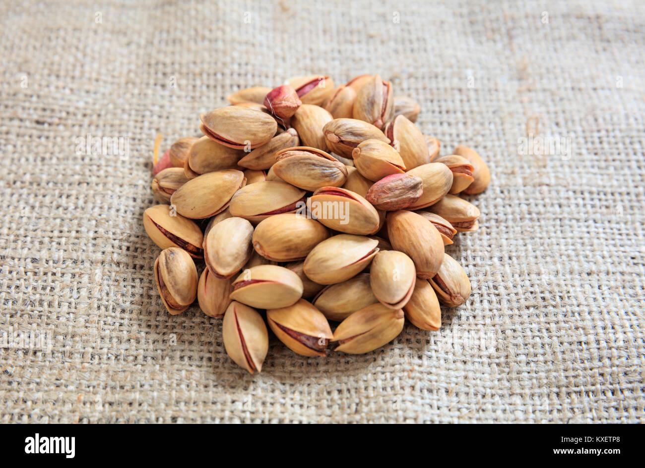 Pistachios in shell on a burlap Stock Photo - Alamy