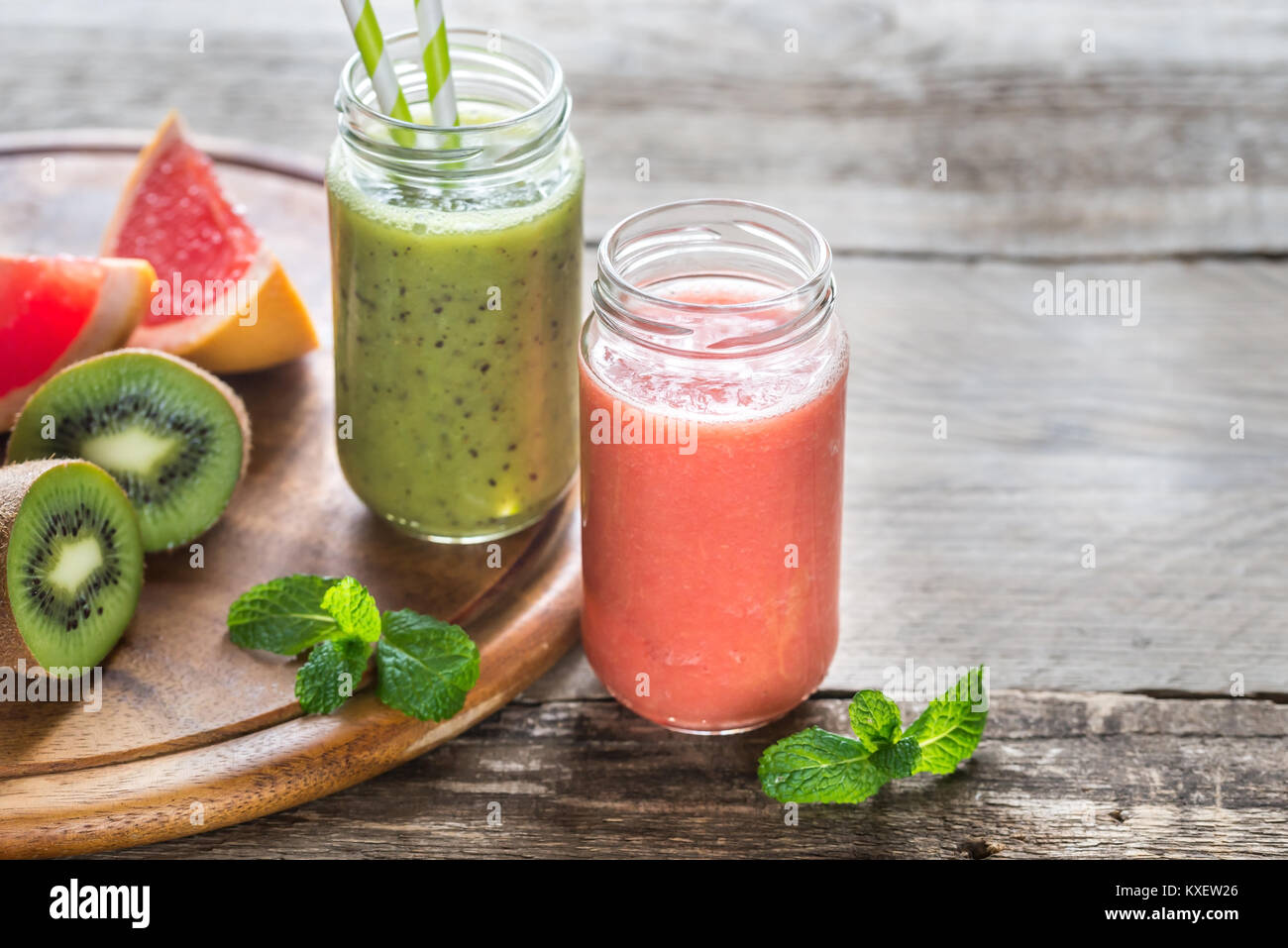Glass jars of fruit smoothies Stock Photo - Alamy