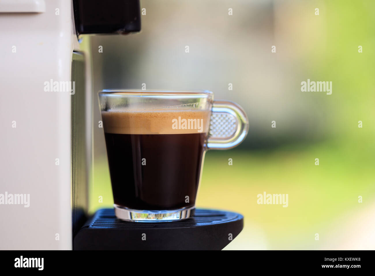 Making espresso. Espresso coffee maker on a blurred background, space ...