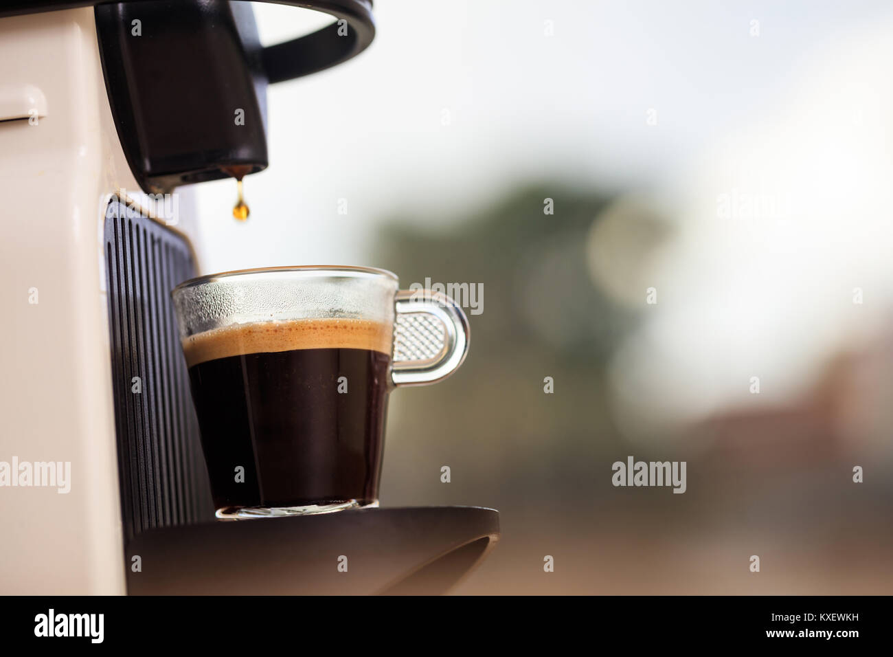Making espresso. Espresso coffee maker on a blurred background, space ...