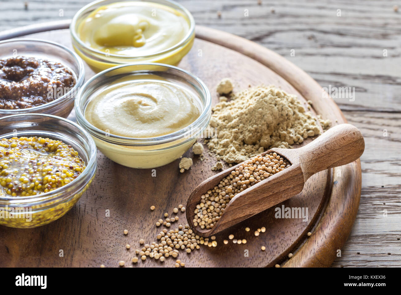 Different kinds of mustard on the wooden background Stock Photo - Alamy