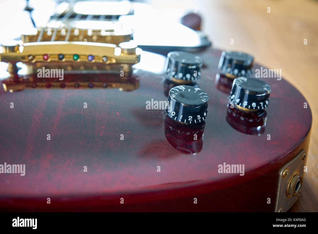 Tone And Volume Knobs On a Shiny Wine Red Guitar With Golden Hardware ...