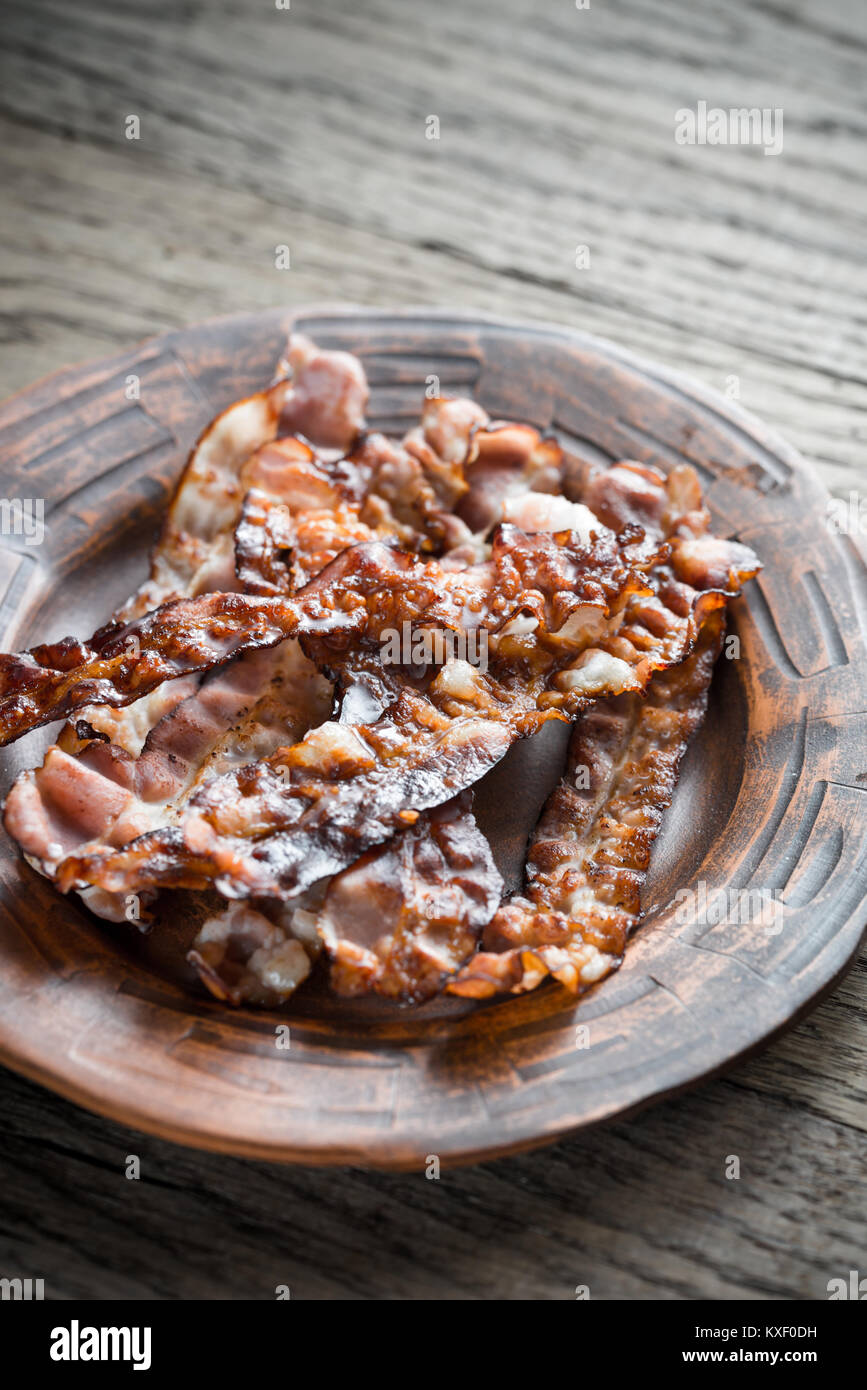 Fried bacon strips on the plate Stock Photo - Alamy
