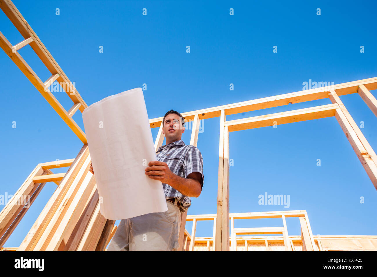Construction workers looking blueprints on hi-res stock photography and ...