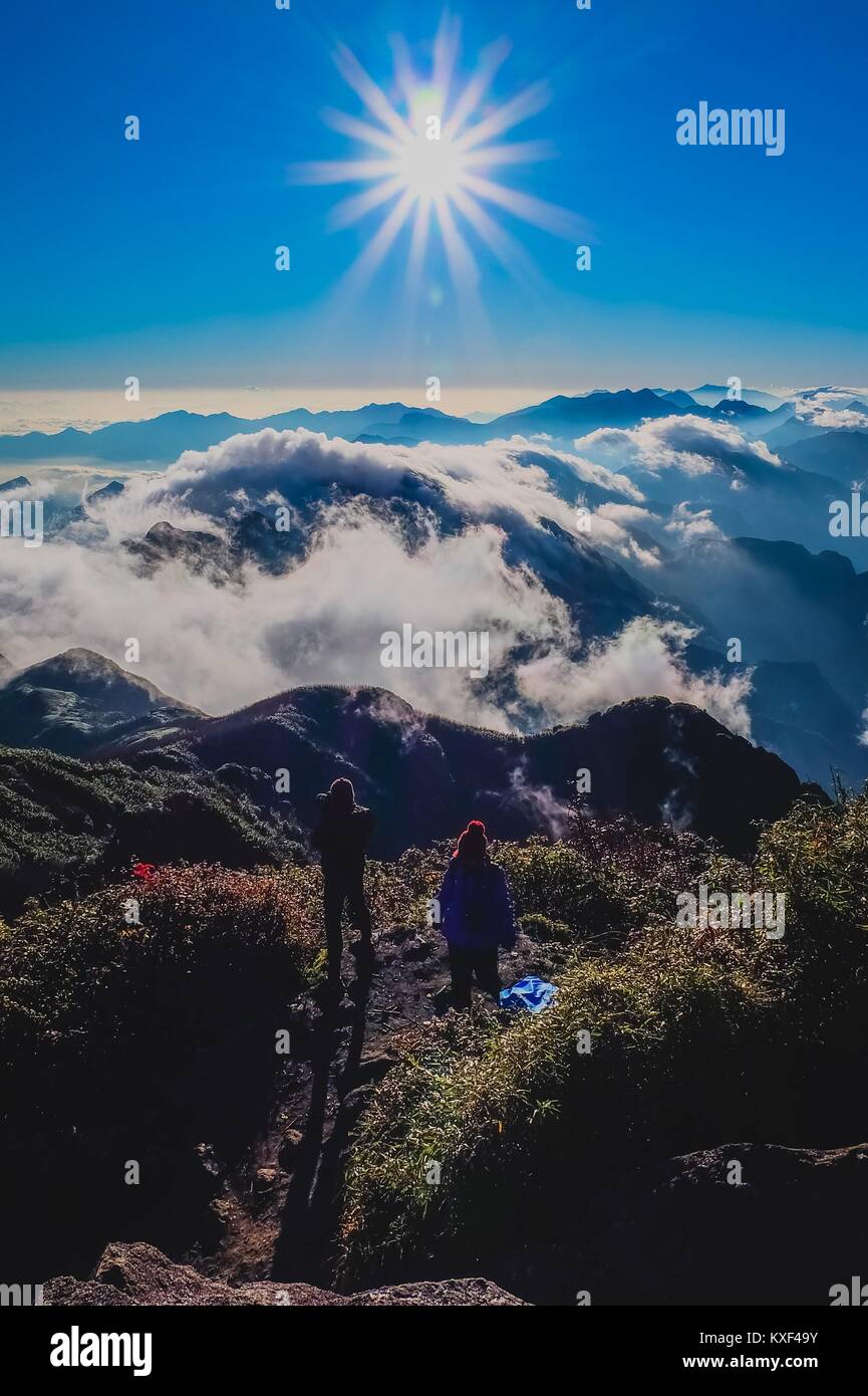 hiker man standing on peak with mountains Landscape of Fansipan Summit ...