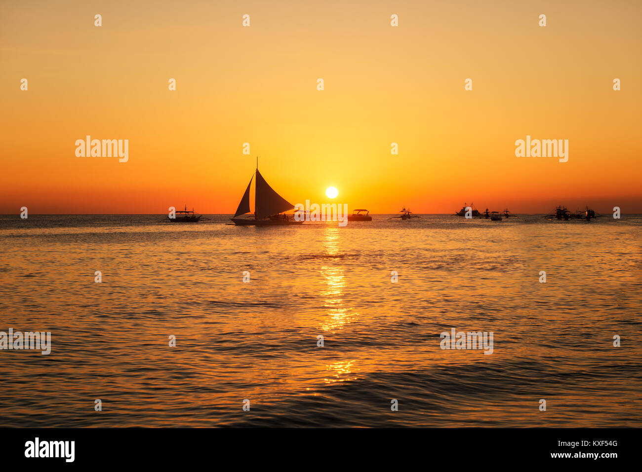 Boats relaxing on the sea at the sunset Stock Photo - Alamy