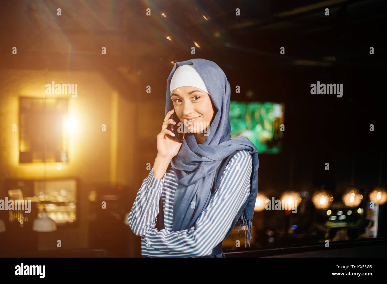 Successful Arab woman. Arab businesswoman wearing hijab talking on cell ...
