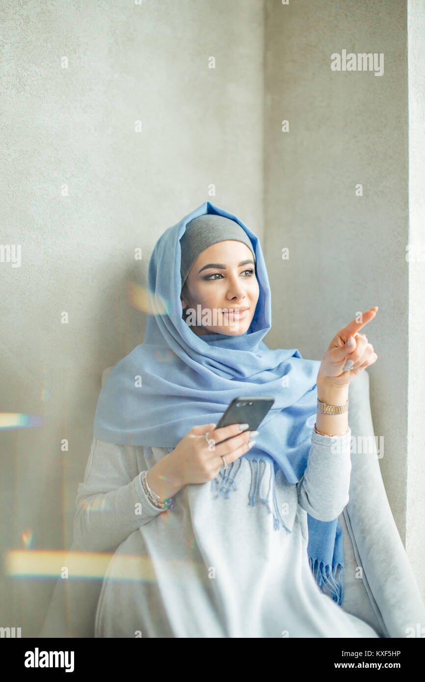 muslim young woman use smart phone in cafe Stock Photo - Alamy