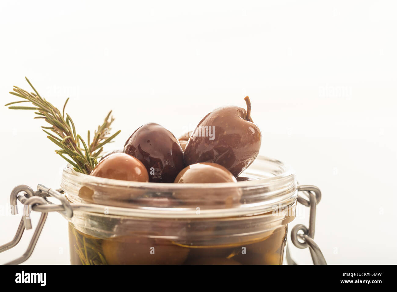 Olives in a glass jar on white background Stock Photo - Alamy