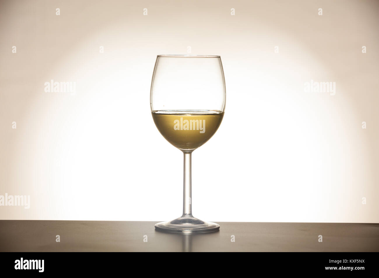 Glass of white wine on gradient background Stock Photo - Alamy