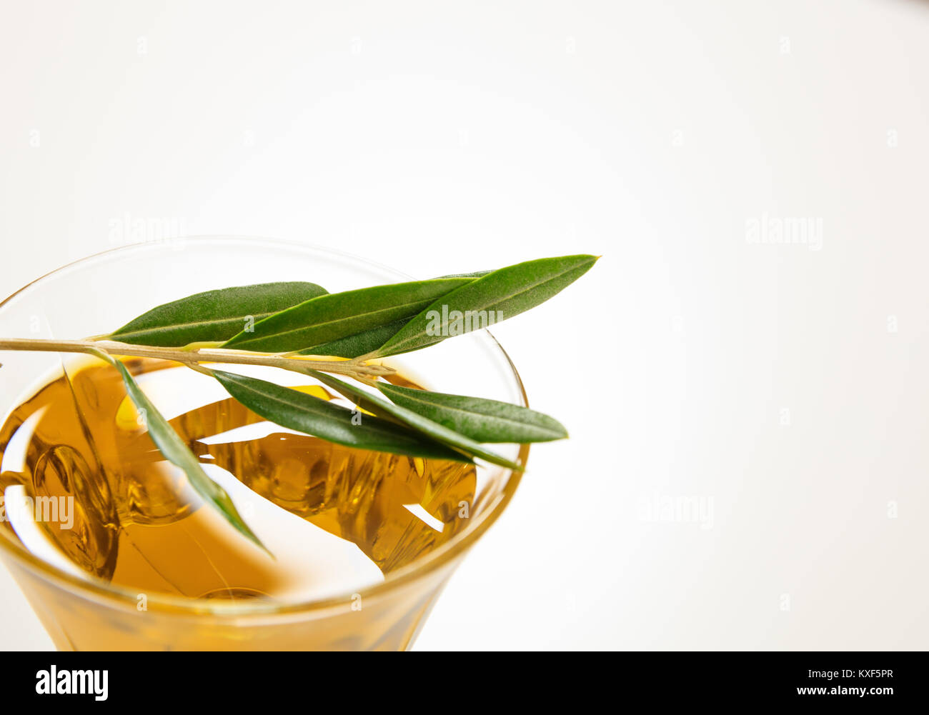 Olive oil and olive twig on white background Stock Photo - Alamy